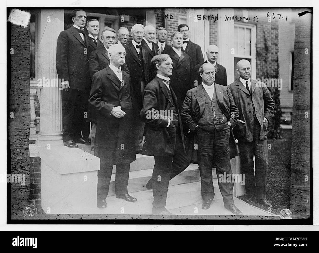 The photograph features Bryan Lind and others on the steps of a ...