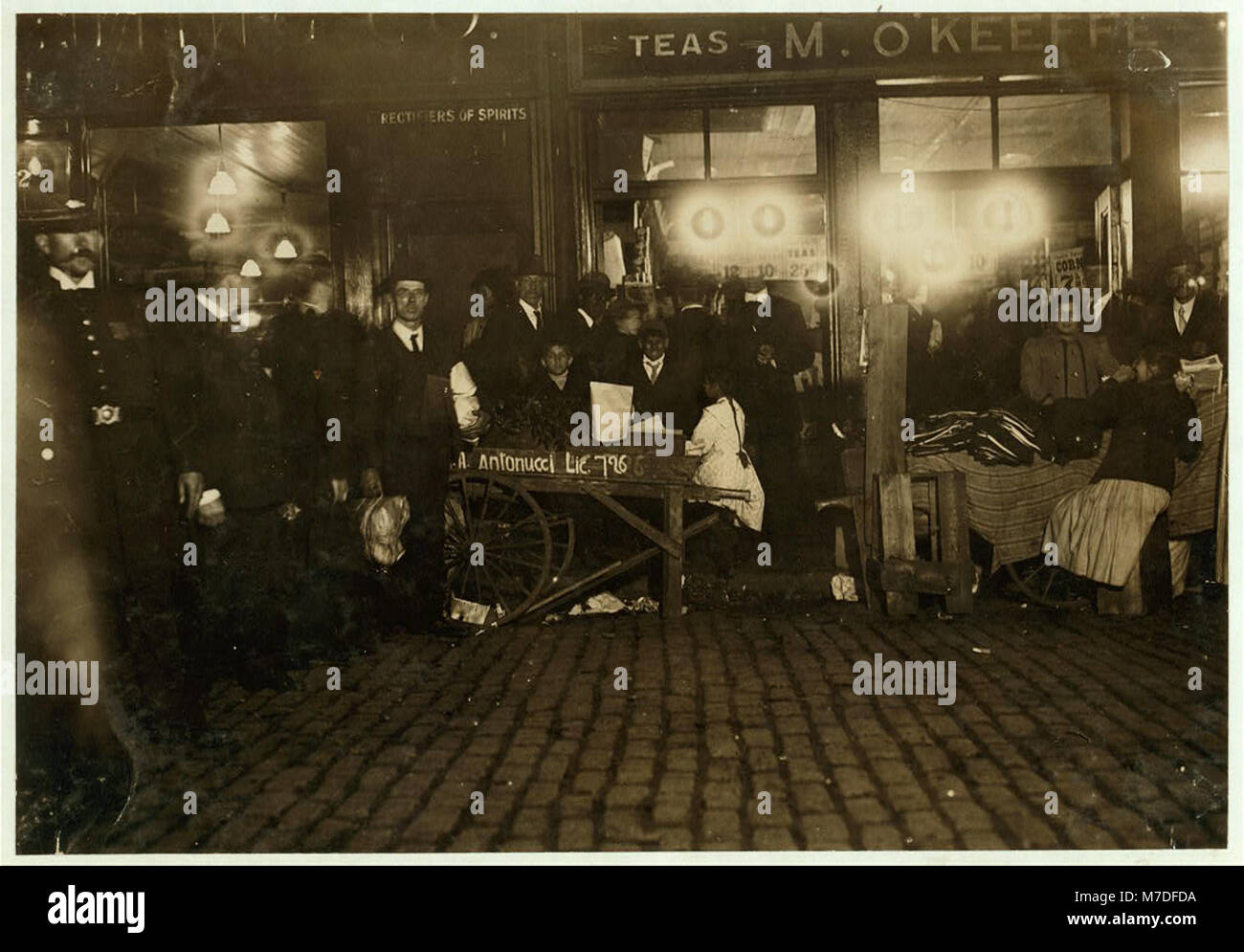 A photograph from 1915 depicting young girls working in a Boston market ...