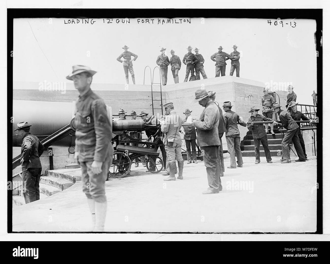 The image shows soldiers loading a 12-foot artillery gun at Fort ...