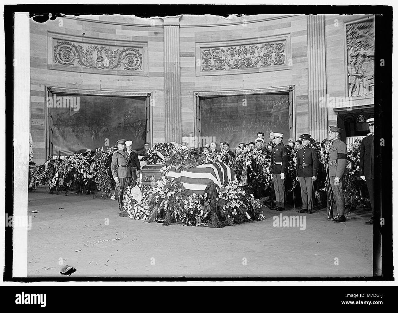 This image shows a prominent figure lying in state at the U.S. Capitol ...