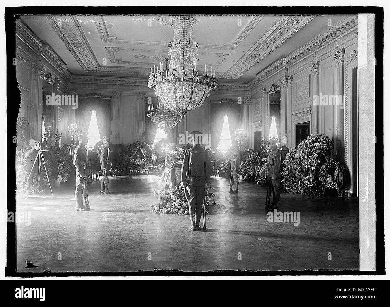This image depicts a somber moment in U.S. history, with a notable ...
