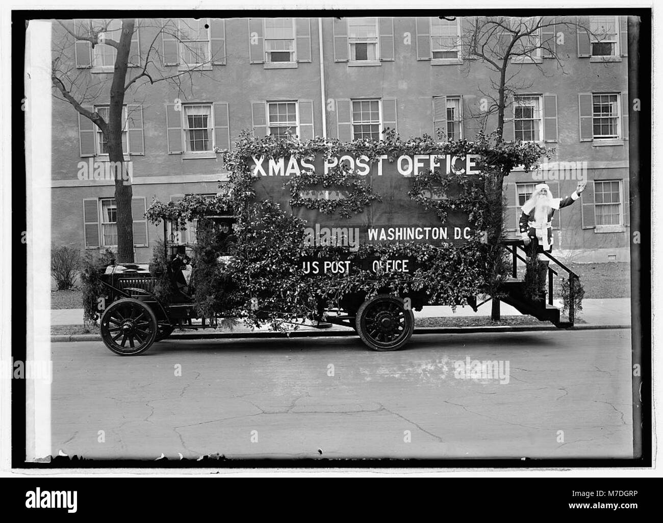 A photograph capturing an early mail delivery parade, showcasing the ...