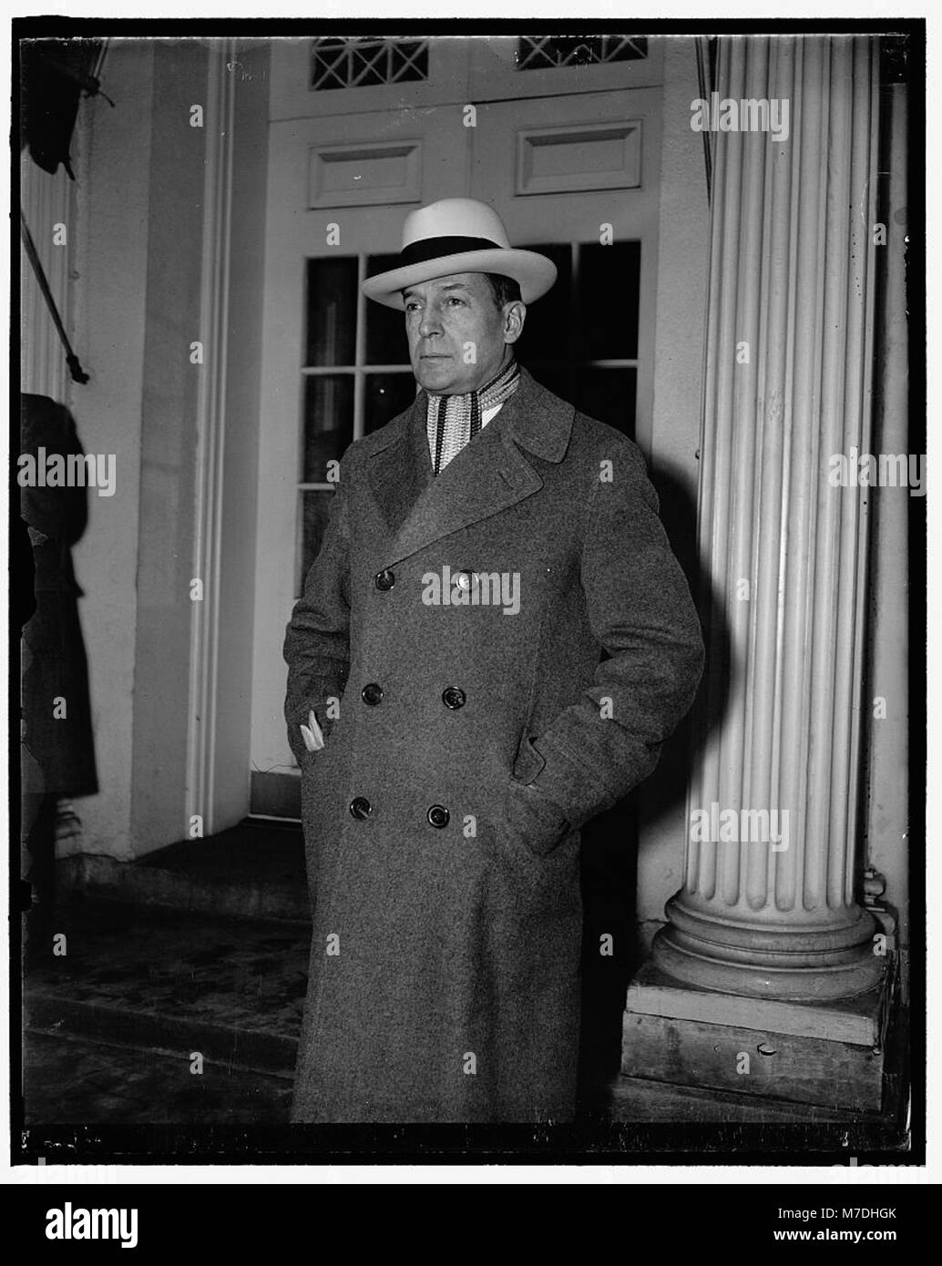 A photograph of a man standing at the White House in Washington, D.C ...