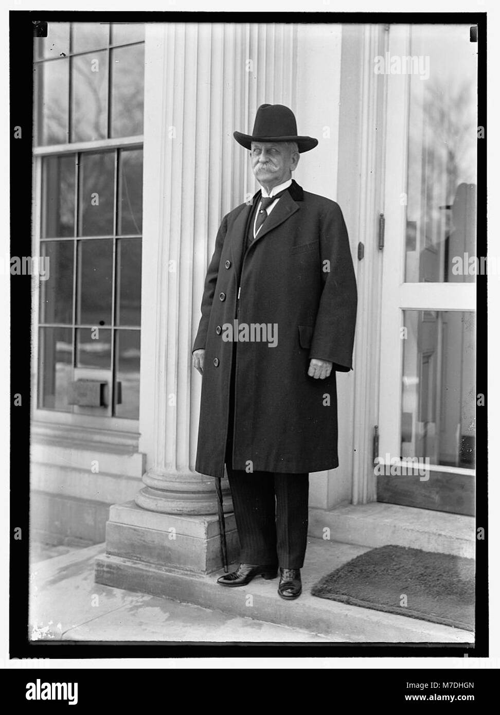 This image shows a man standing at the White House in Washington, D.C ...