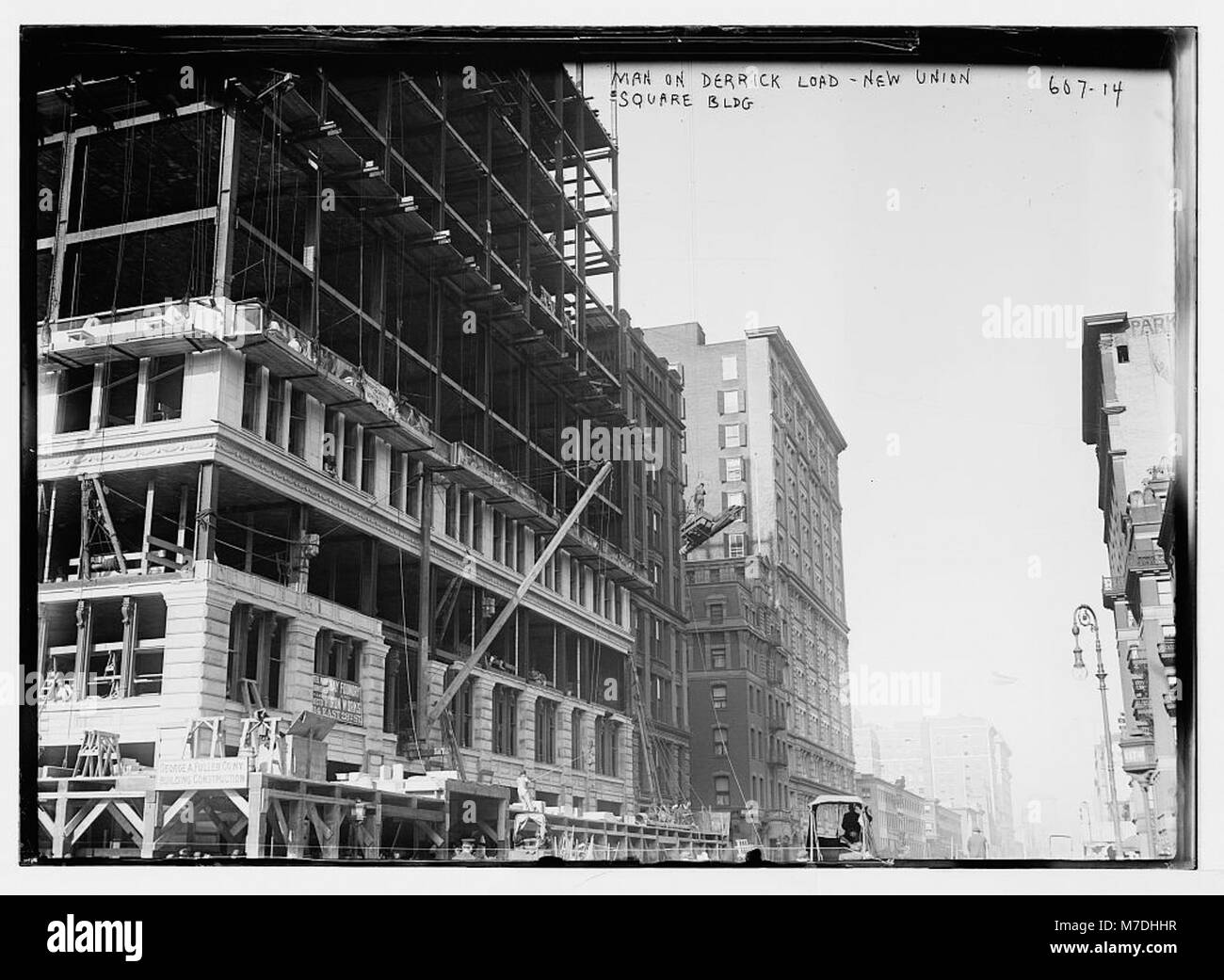 This image shows a man working on a derrick, loading materials onto the ...