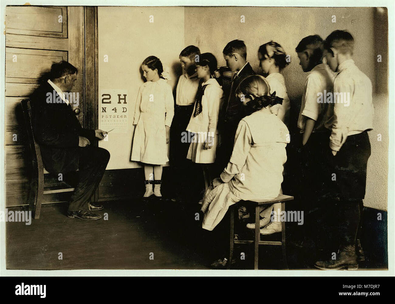 This photograph shows a medical inspection and eye testing session ...