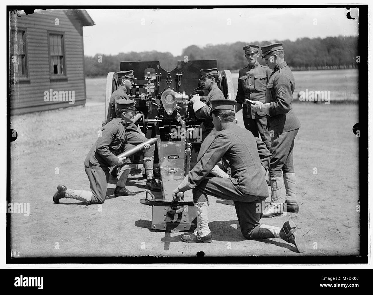 A photograph depicting men operating artillery in a military setting ...