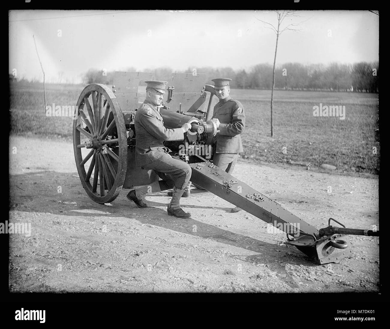 A historical photograph showing men operating artillery, likely during ...