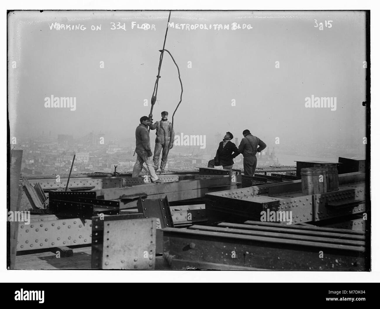Photograph depicting men working on the 33rd floor of the Metropolitan ...