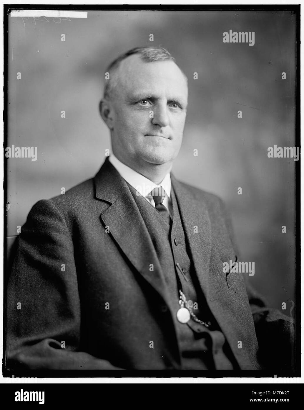 This image features an official portrait of a U.S. governor, identified ...