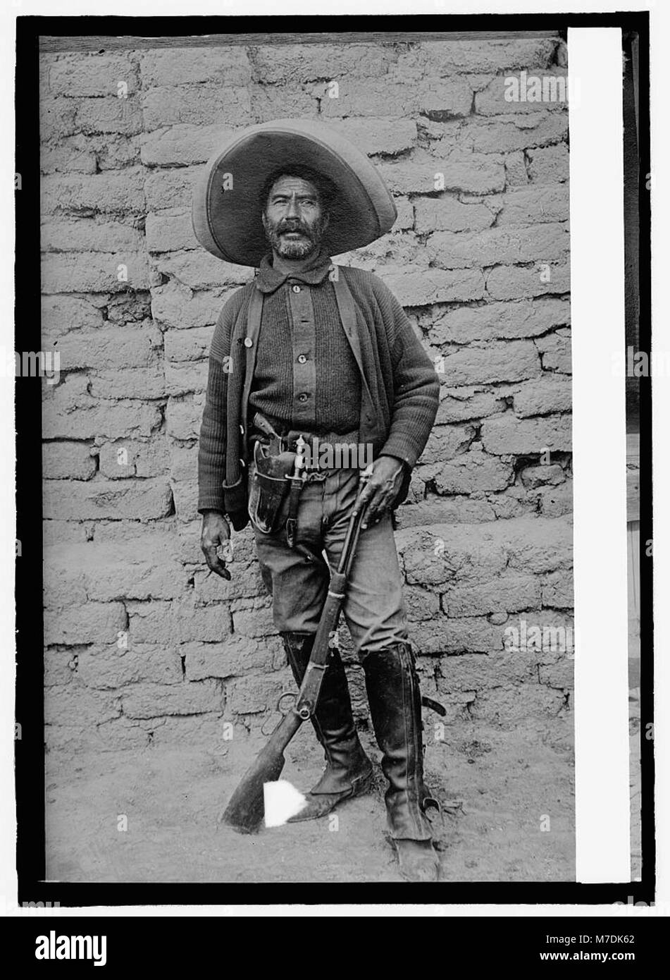 A peon volunteer in Mexico, depicted in a historical photograph. The ...