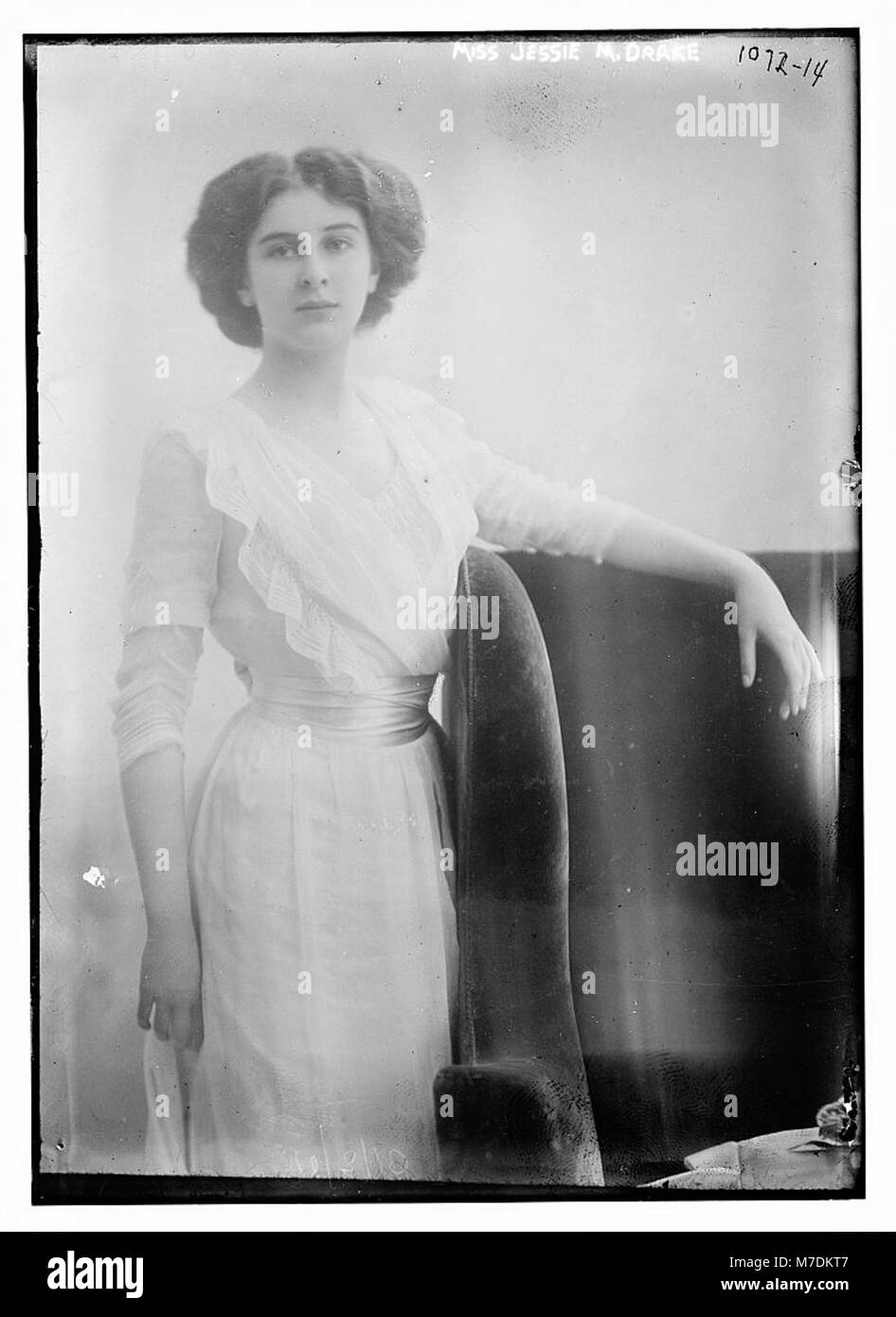 Miss Jessie M. Drake standing by chair LCCN2014685205 Stock Photo - Alamy