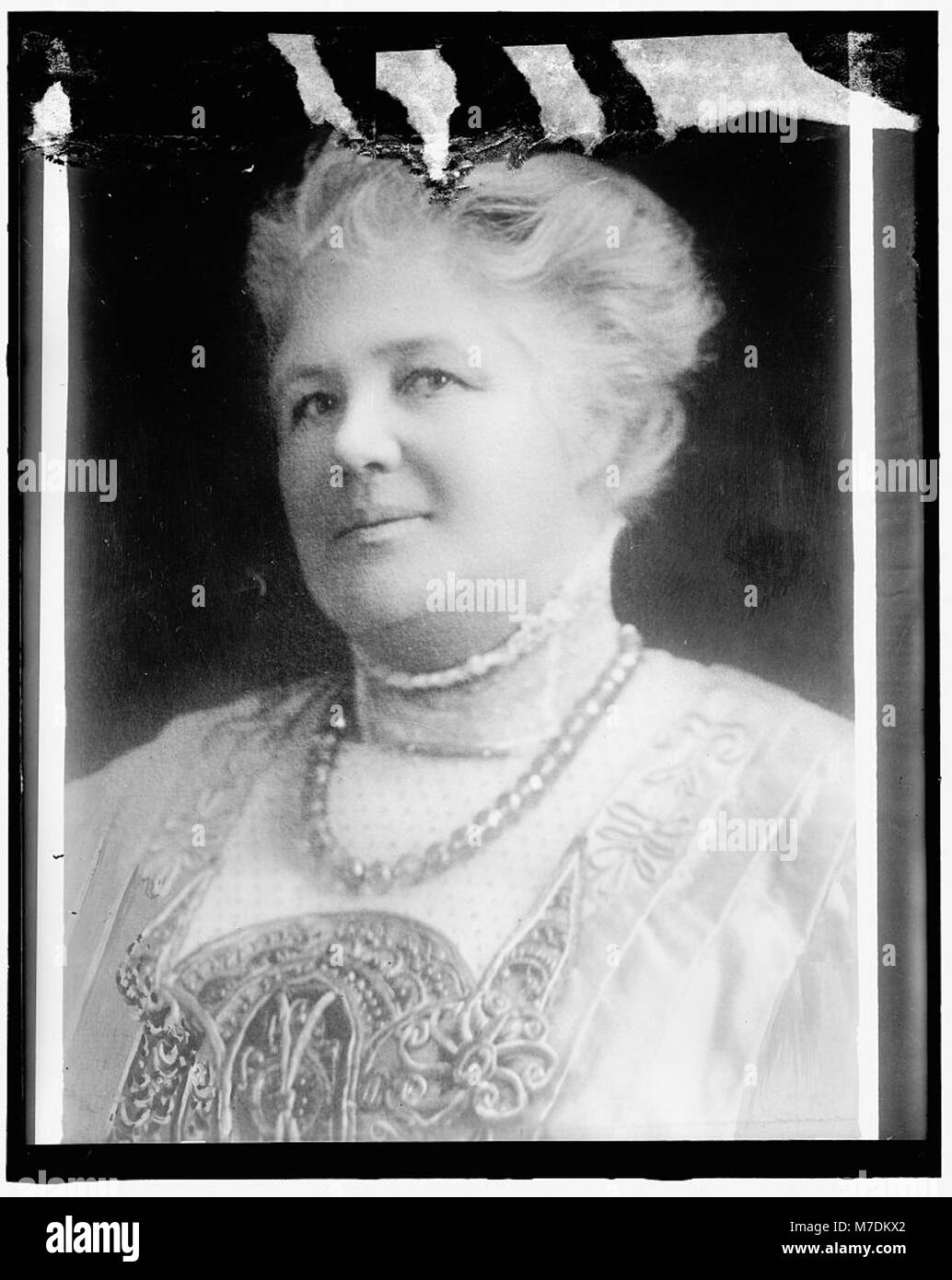 A photograph featuring Miss Mary E. Foy, captured in a formal setting ...