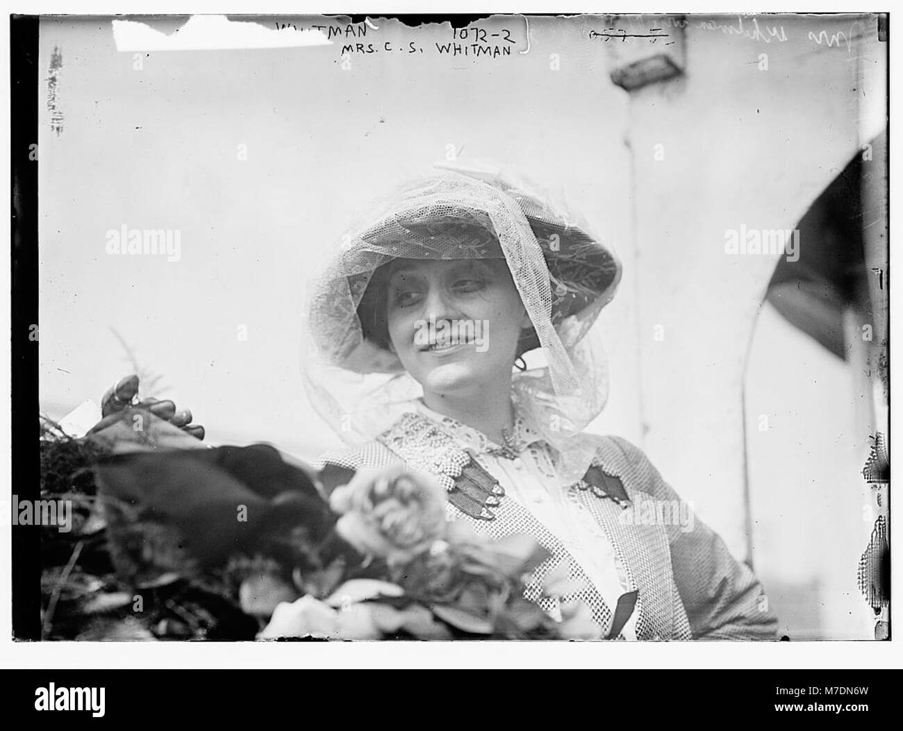 A formal portrait of Mrs. C.S. Whitman, capturing her likeness in a ...