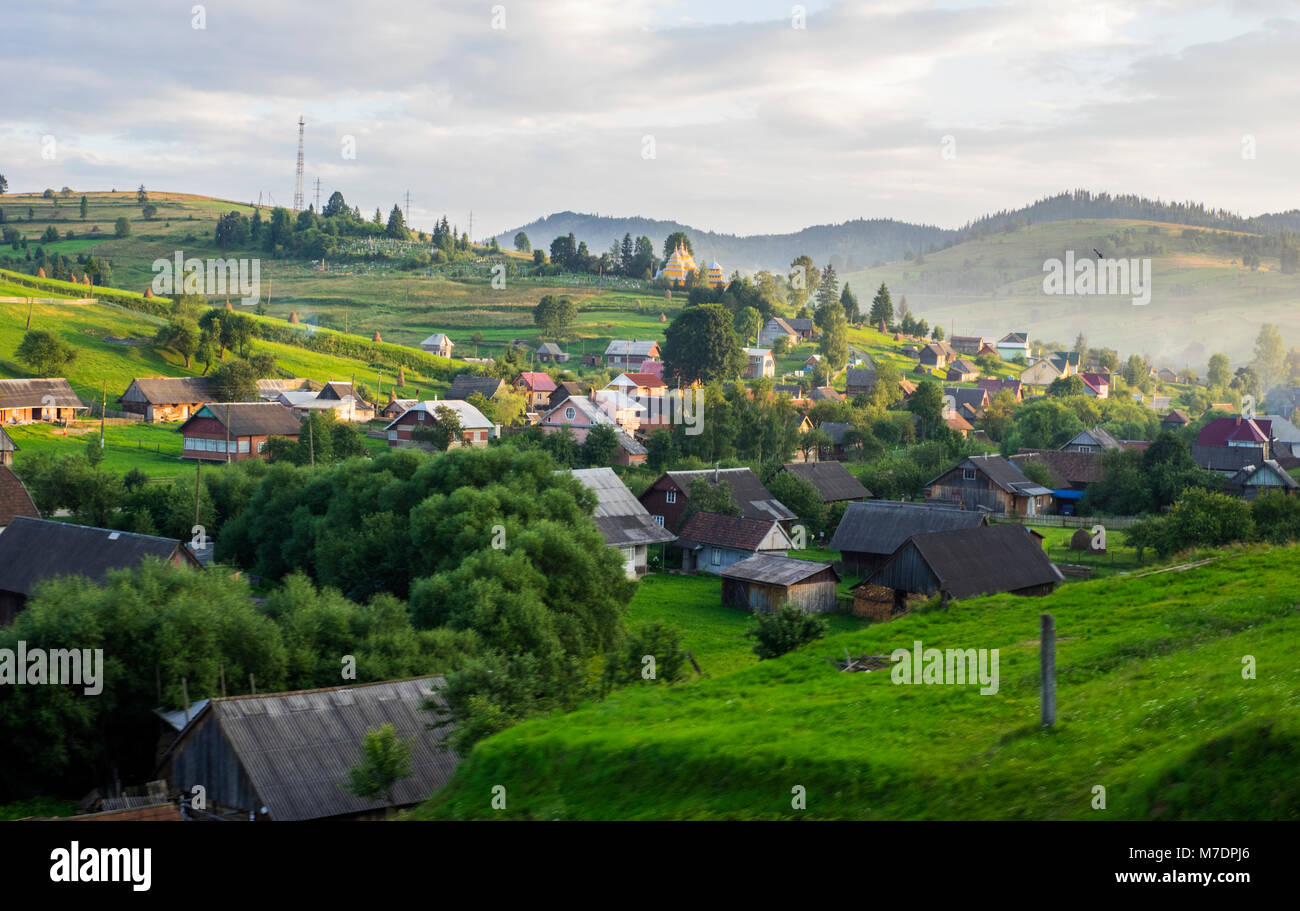 Bright rolling countryside around a farm in the morning light ...