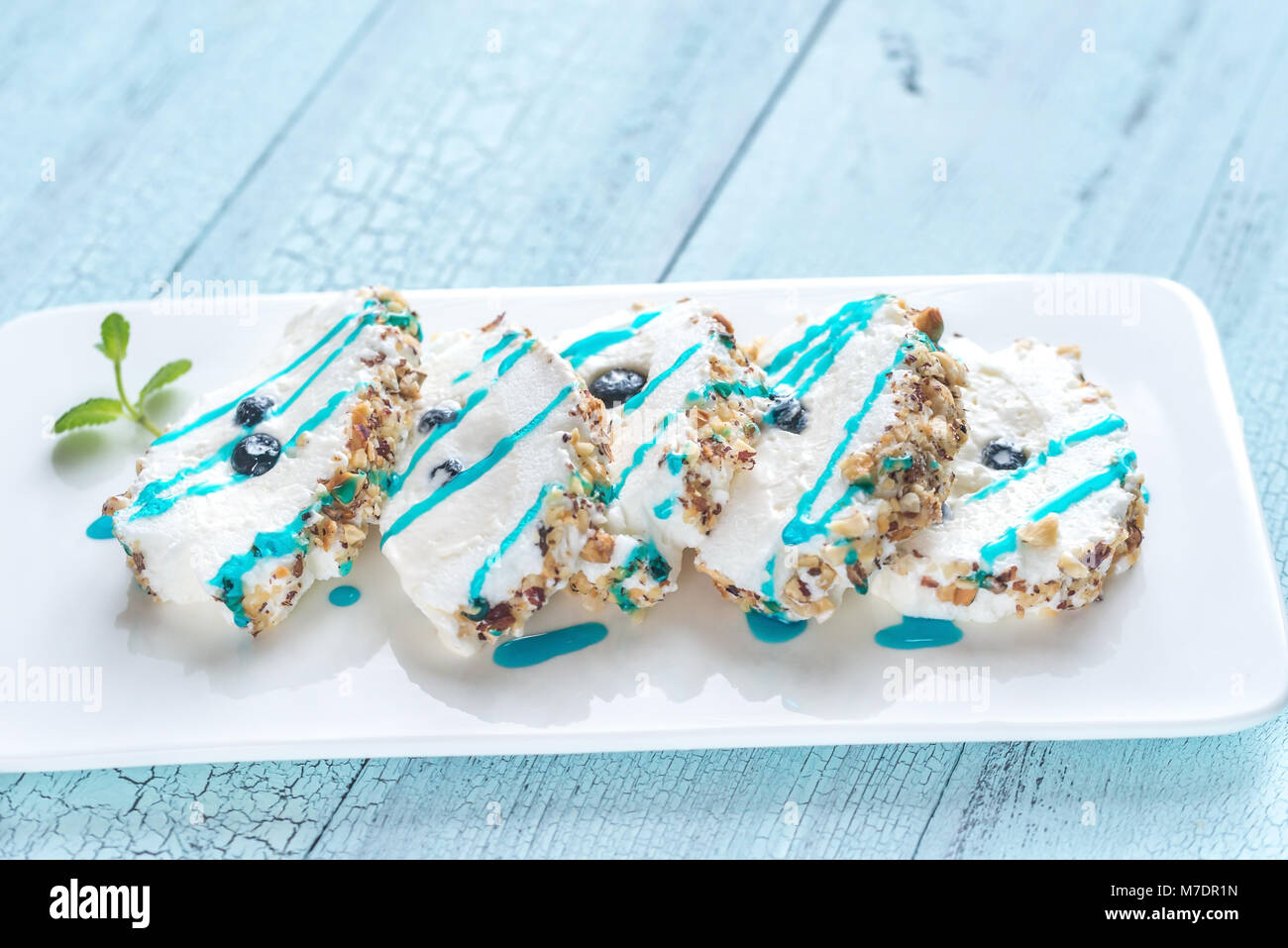 Sliced merengue roll with nuts Stock Photo - Alamy