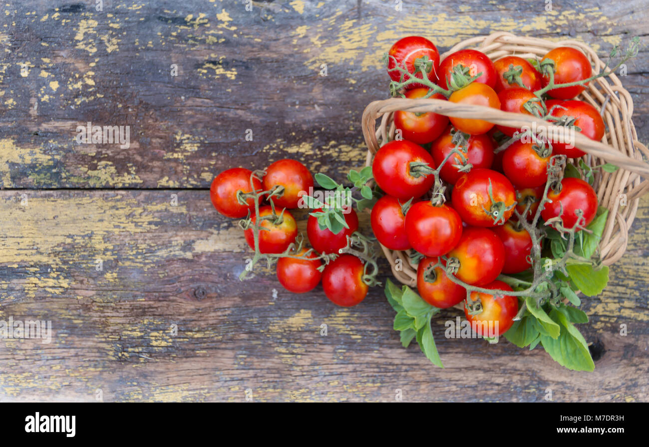 rustic kitchen background with cherry tomatoes ru Stock Photo - Alamy