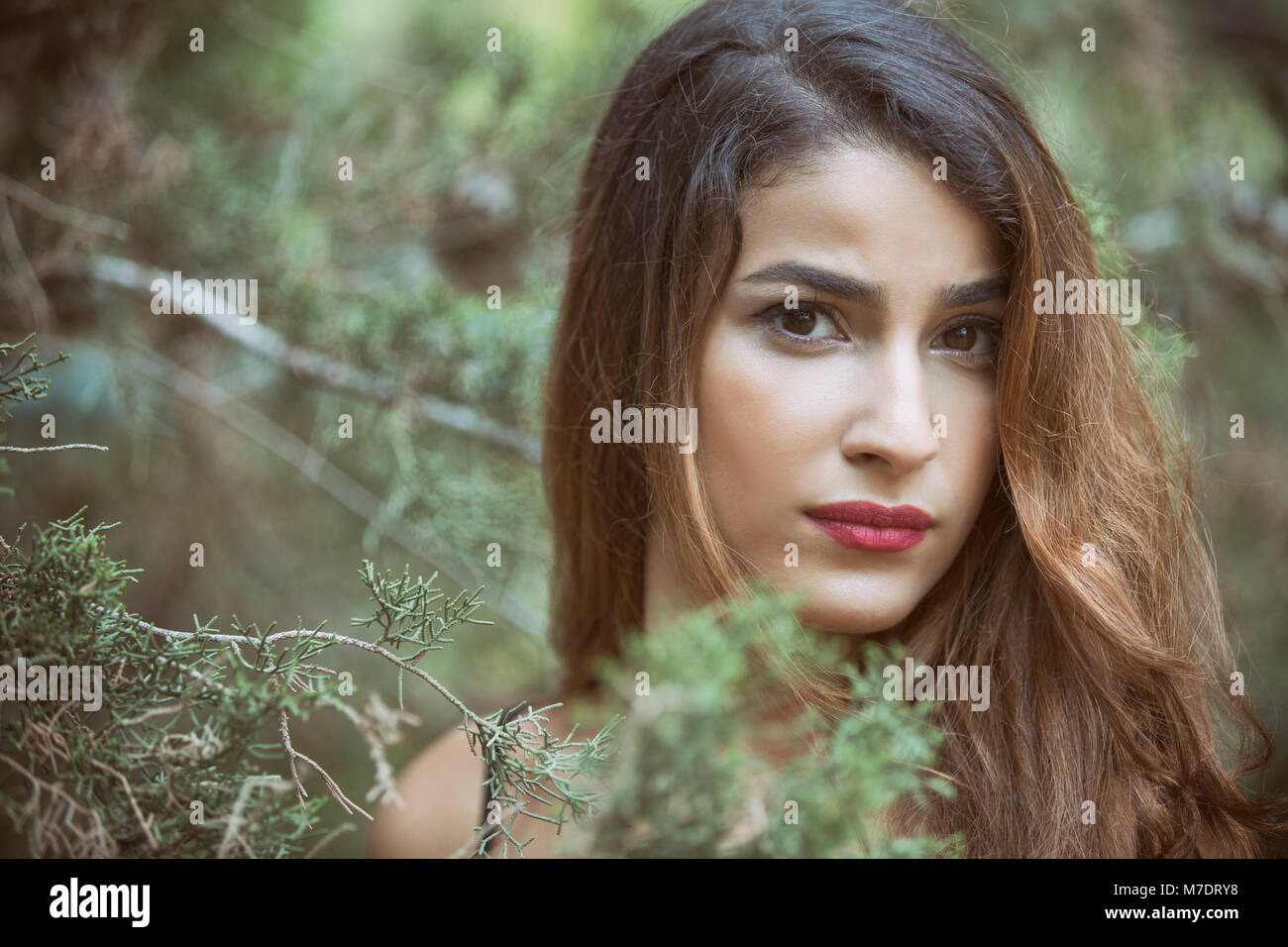Serious young woman staring outdoors Stock Photo - Alamy
