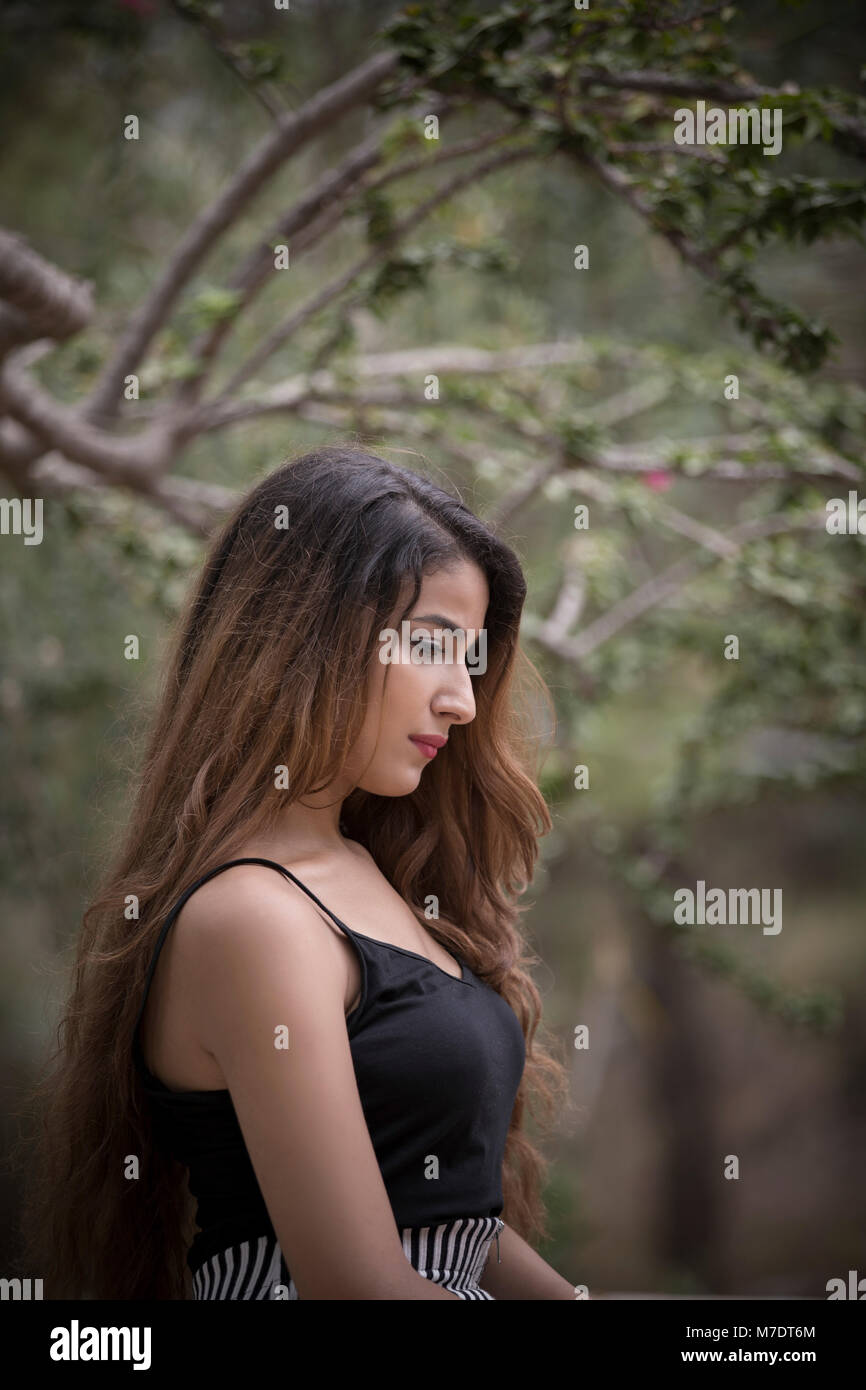 Side view of a sad young woman outdoors Stock Photo - Alamy