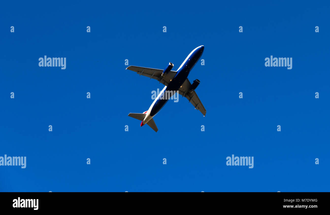 Passenger plane flying in the blue sky, cruise aircraft, transport ...