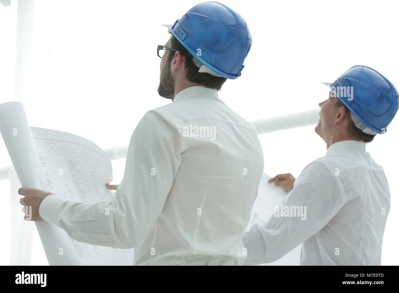 rear view.architect and Builder looking at blank screen Stock Photo - Alamy