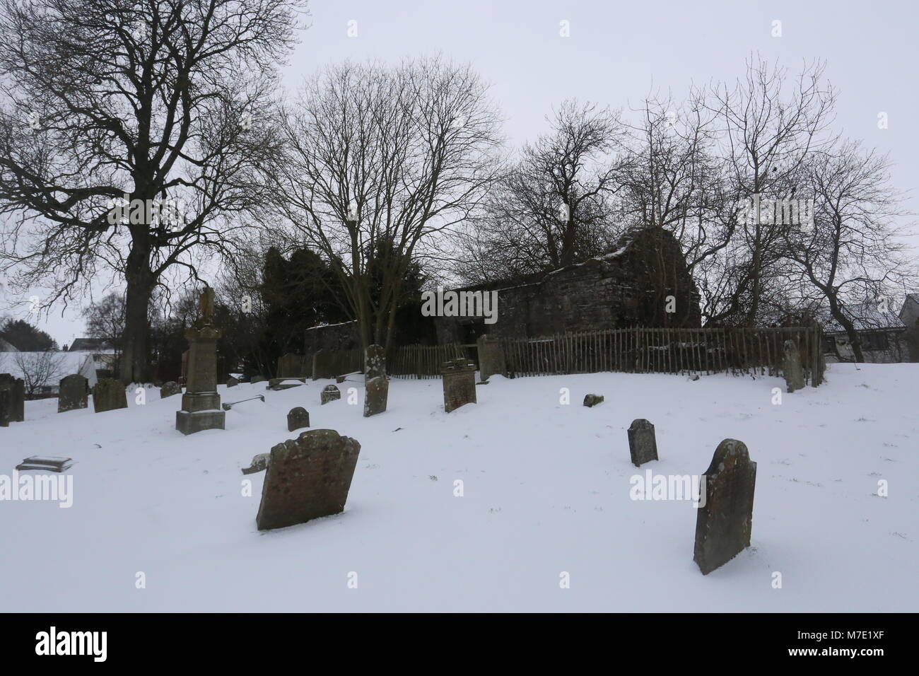Ruin of St Peter's Church and graveyard with snow Invergowrie Scotland ...