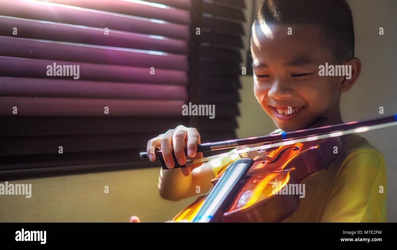 Young Asian boy learning to play violin Stock Photo - Alamy