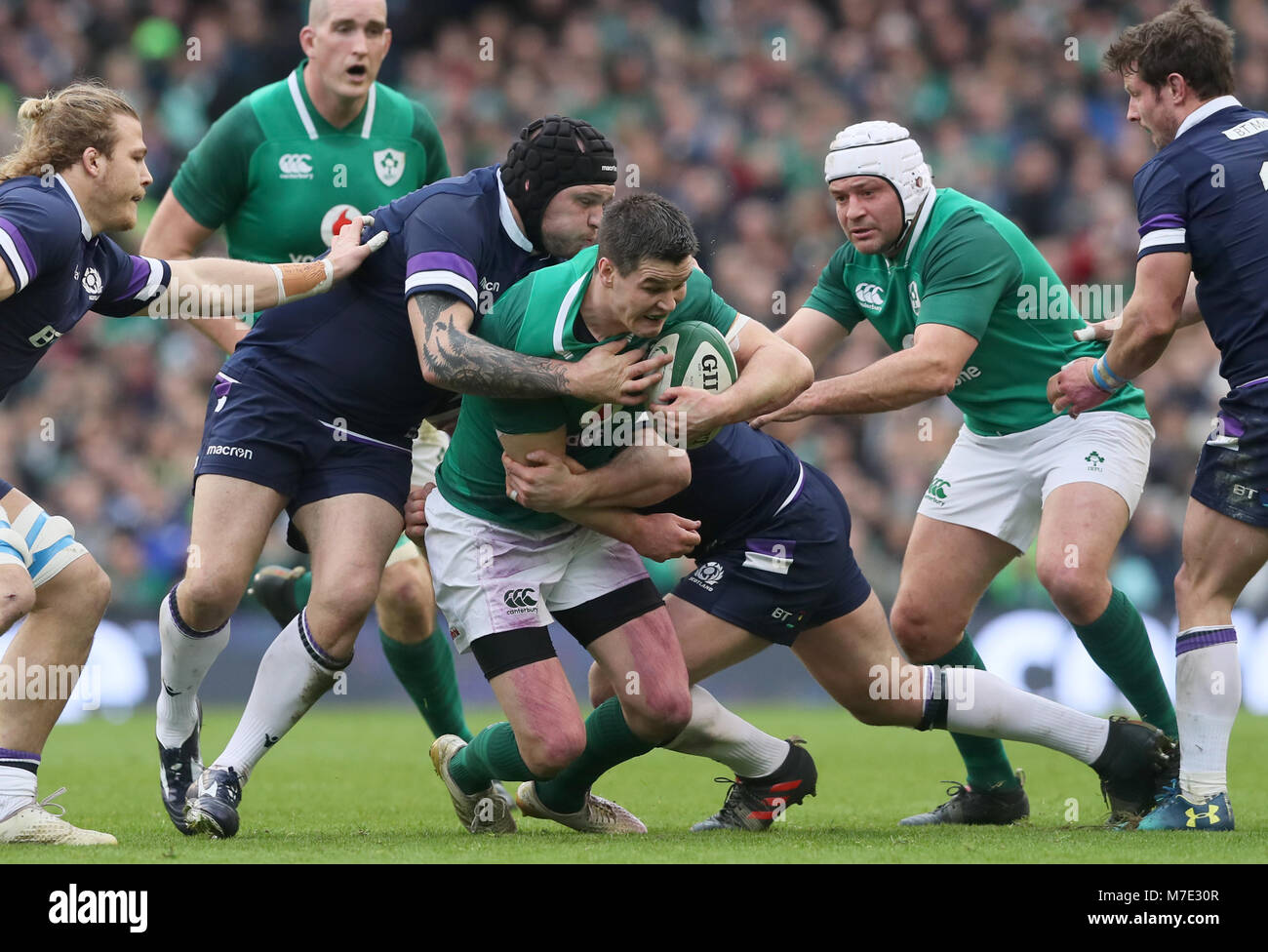 Ireland's Johnny Sexton (centre) is tackled by Scotland's Gordon Reid ...