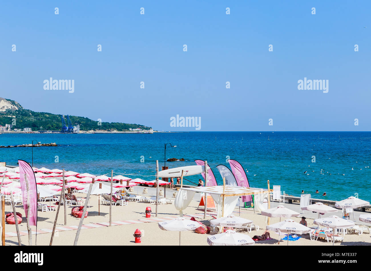 The Balchik seaside, beach with sands, sun umbrellas and blue water ...