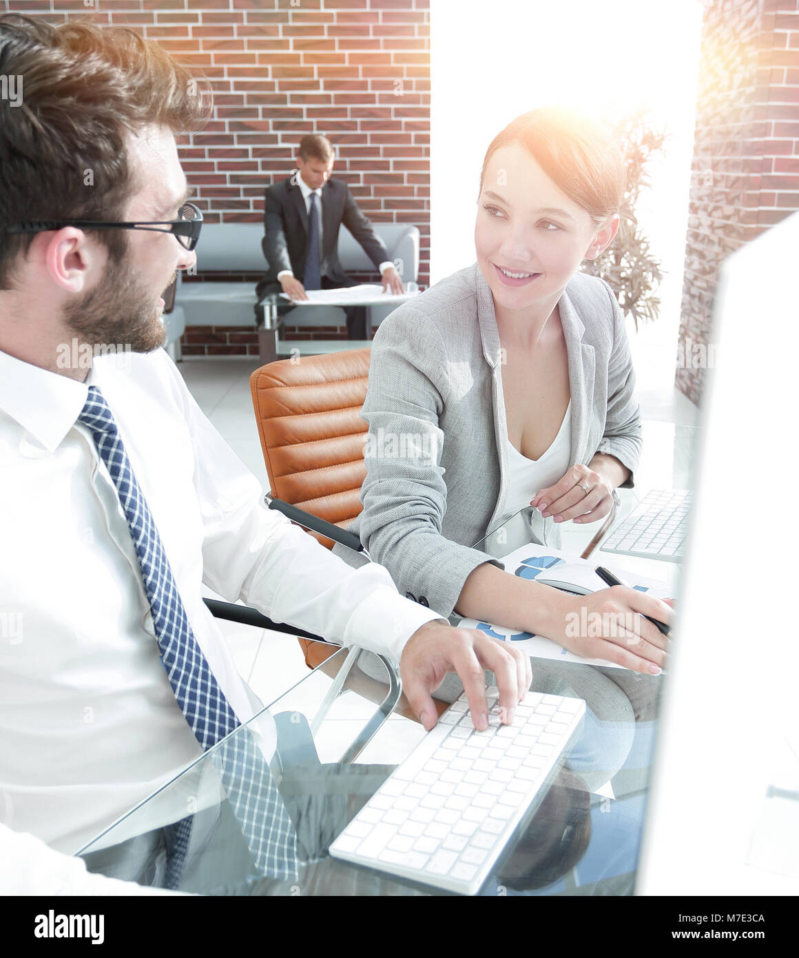 young professionals sitting behind a Desk Stock Photo - Alamy