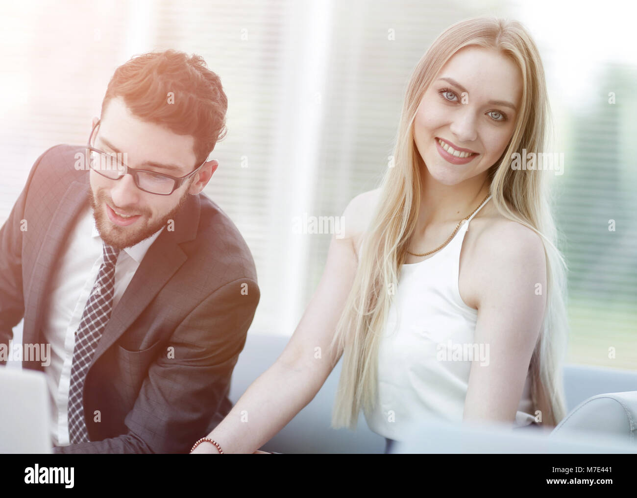 manager and client browsing information on the laptop Stock Photo - Alamy