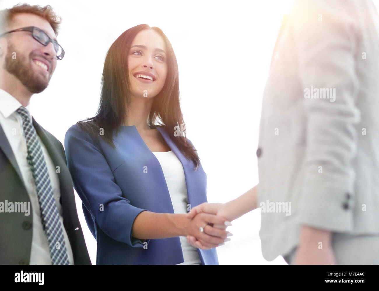 Businesswomen Shaking Hands In Modern Office Stock Photo - Alamy
