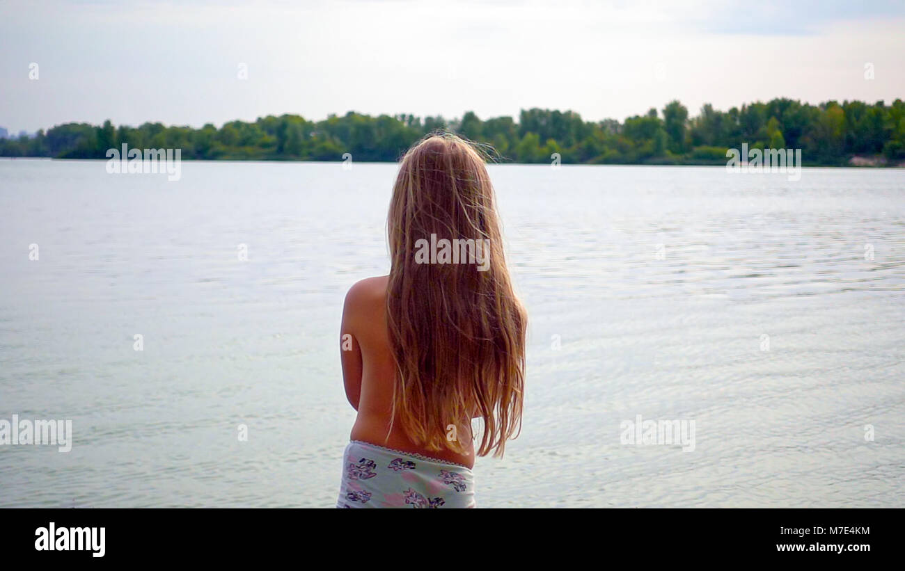 Little cute longhair girl at riverside Stock Photo - Alamy