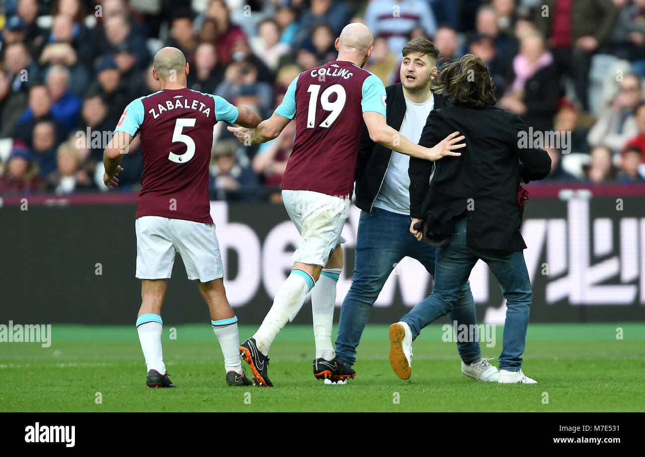 Pitch invaders run onto the pitch during the Premier League match at ...