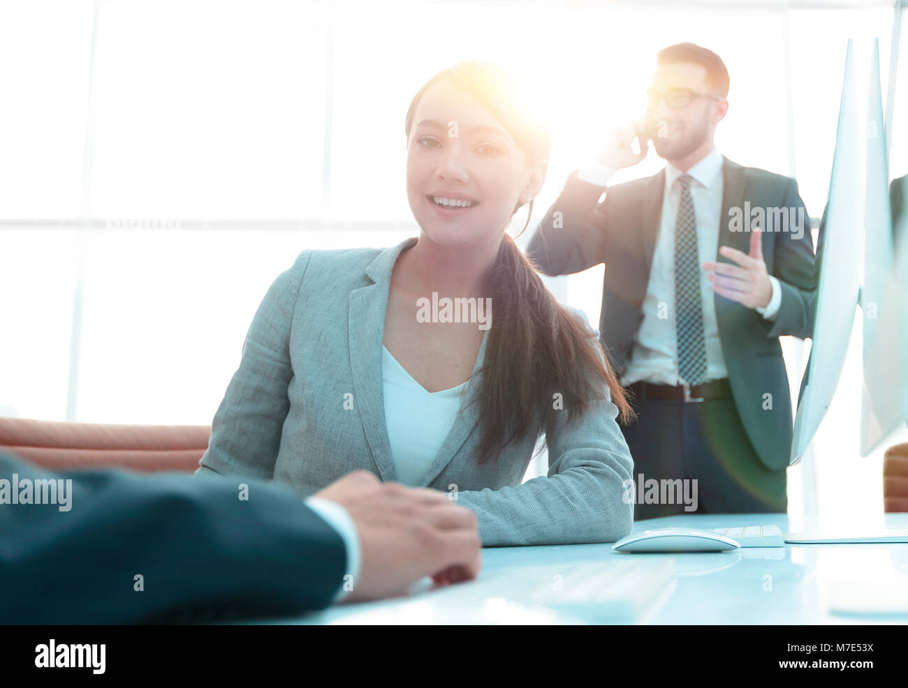 female consultant sitting at her Desk Stock Photo - Alamy