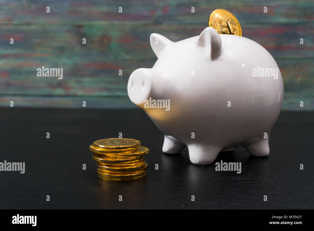 White piggy bank with one gold bitcoin coin Stock Photo - Alamy
