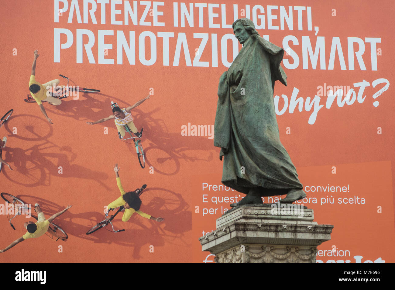 Statue in front of a marketing billboard, Milan, Italy Stock Photo - Alamy