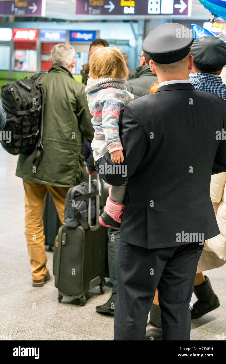 Pilot with his family at the airport. The child is in the hands of the ...