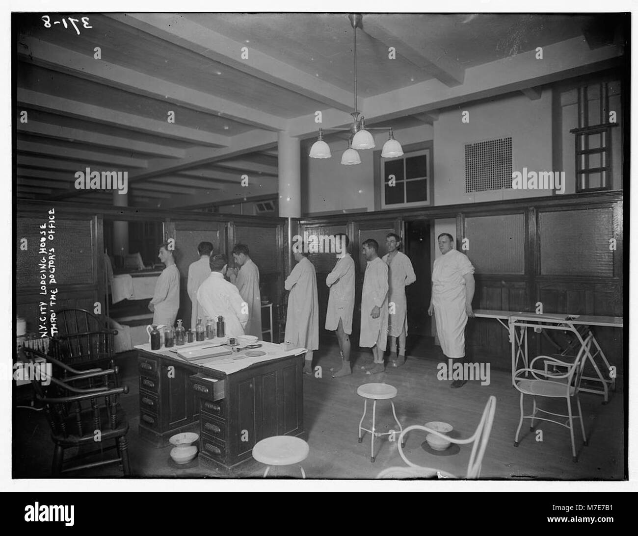 A health inspection at the New York Municipal Lodging House is depicted ...