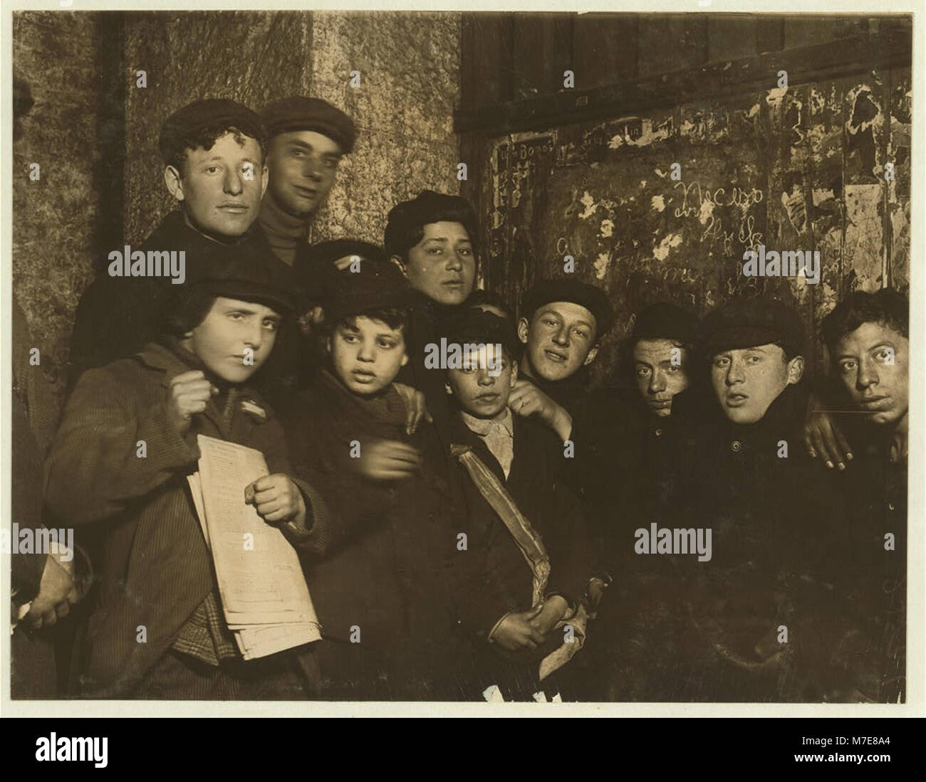 A photograph showing a newsie in a cramped cellar-room behind a Main ...