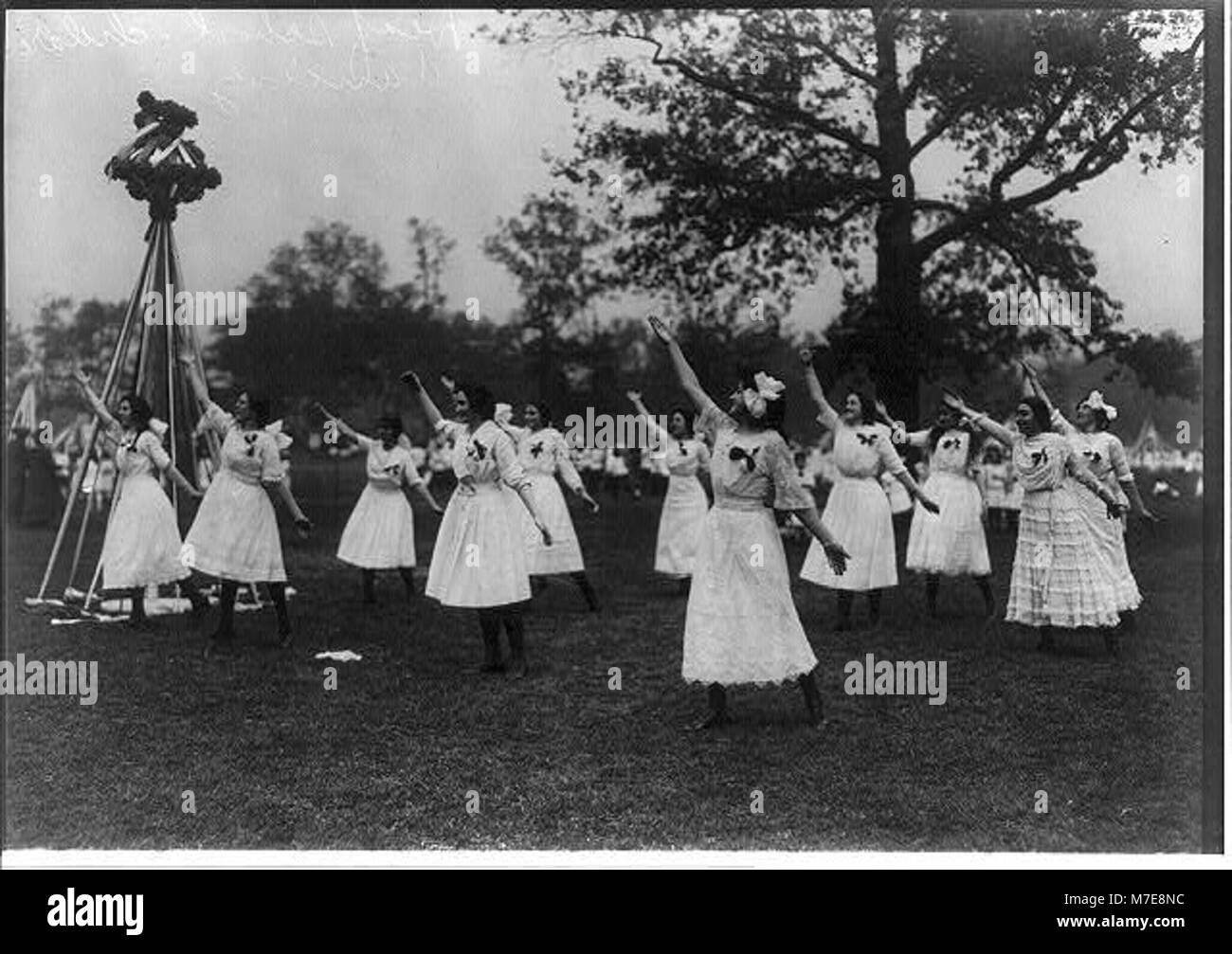 Teen-aged girls dancing around a Maypole in New York City during May ...