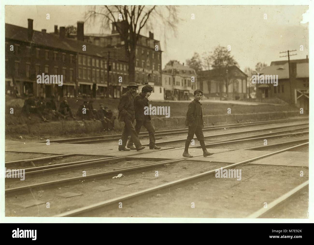 This photograph shows boys working during the noon hour on May 19, 1909 ...