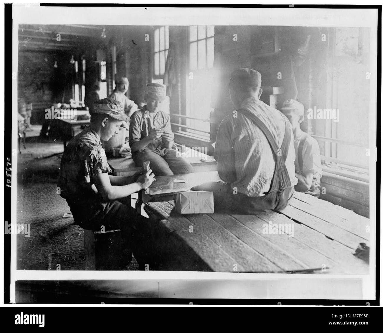 This photograph captures workers during the noon hour in a furniture ...