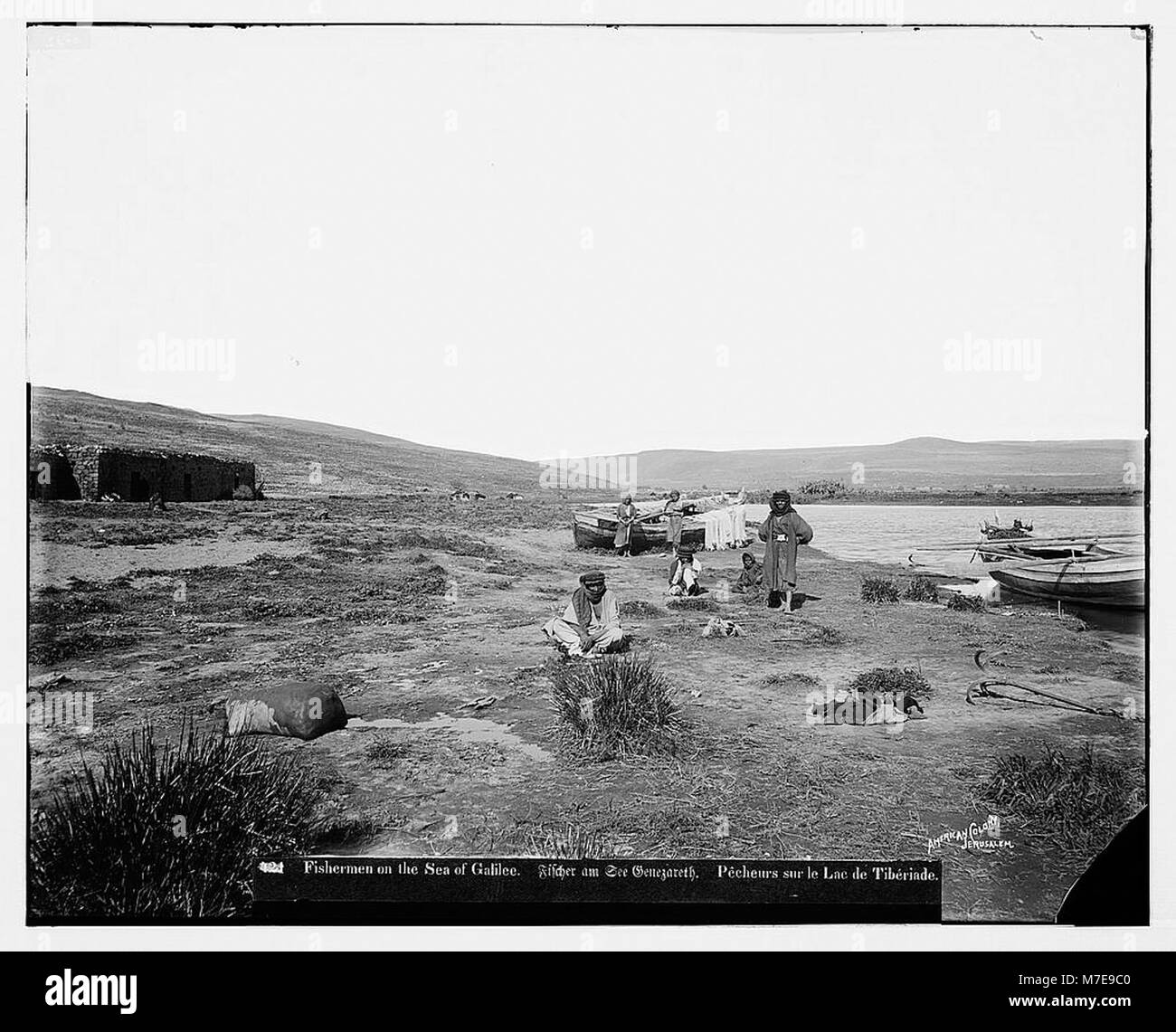 A serene view of people fishing on the Sea of Galilee, showcasing the ...