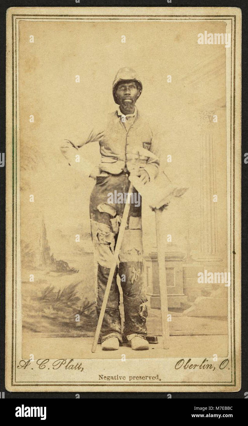 This image shows an African American bricklayer in his work attire ...