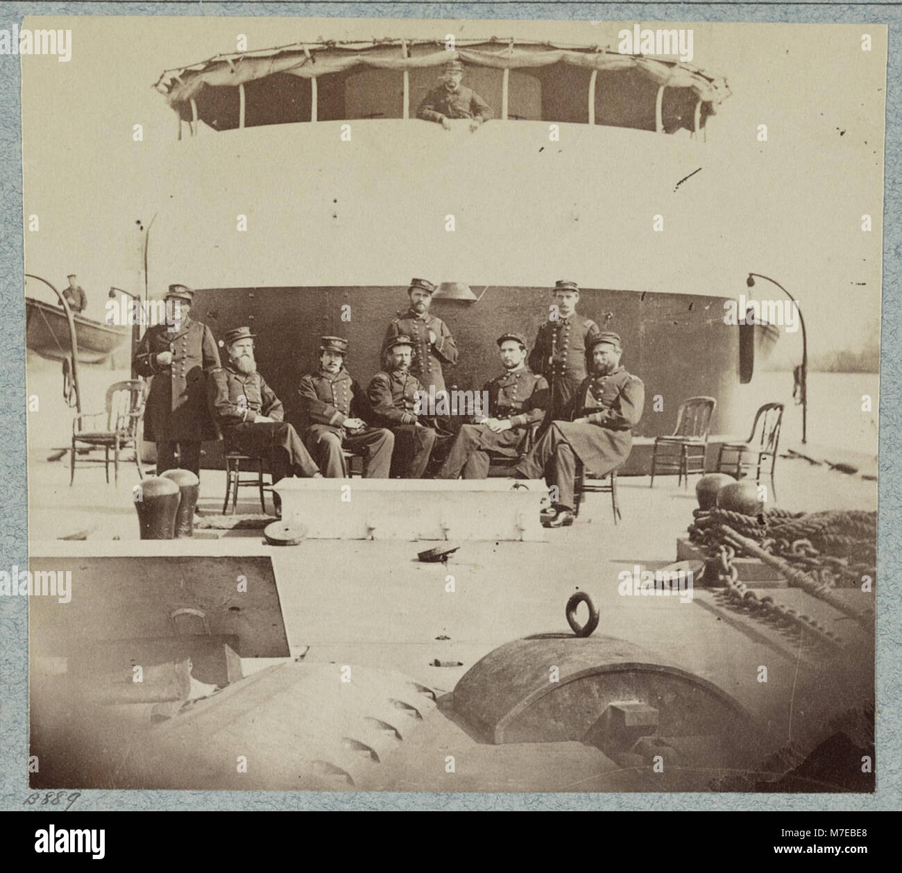 This historical photograph shows officers on the deck of the USS ...