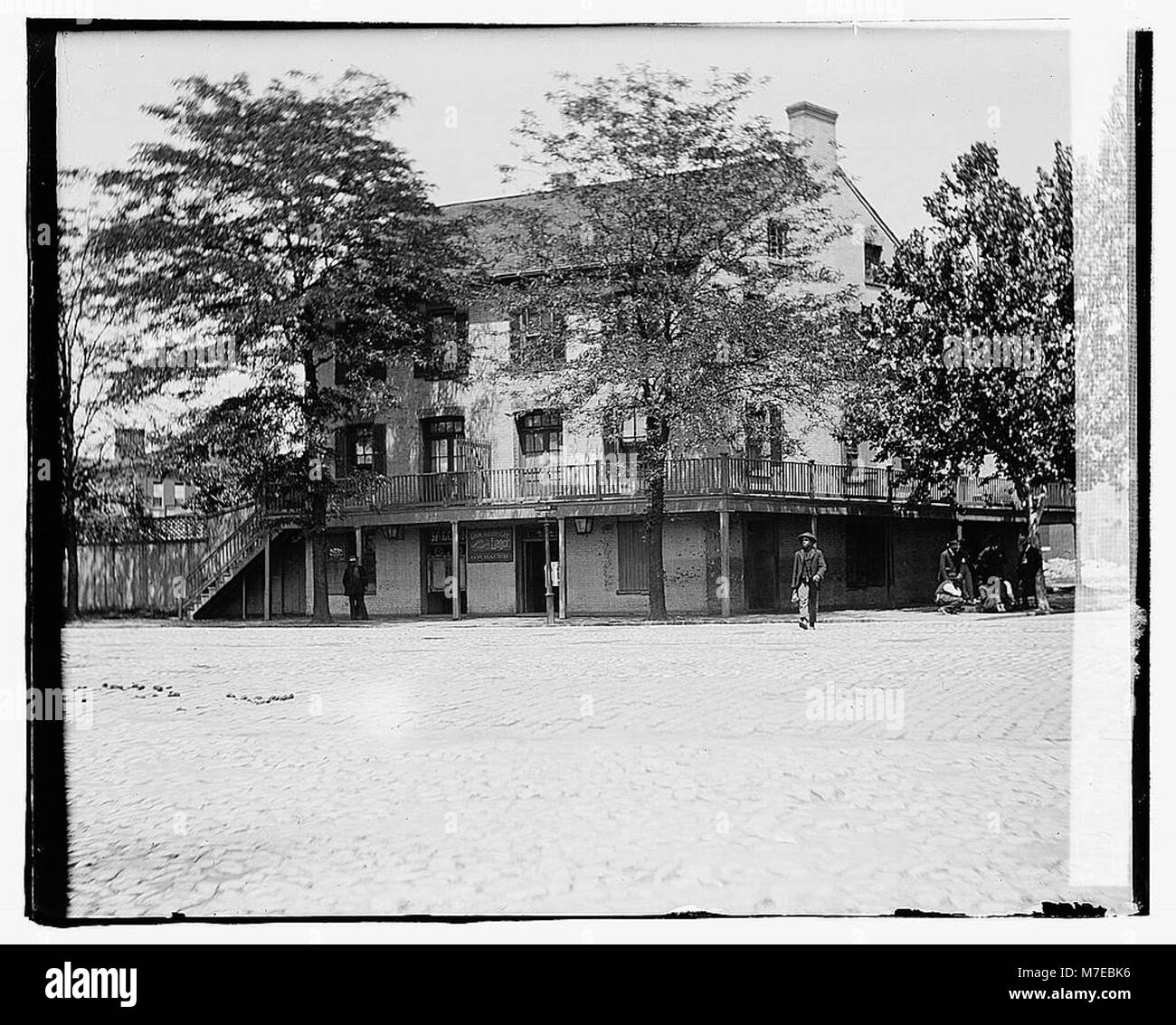 This photograph shows an old house located near a water body in ...