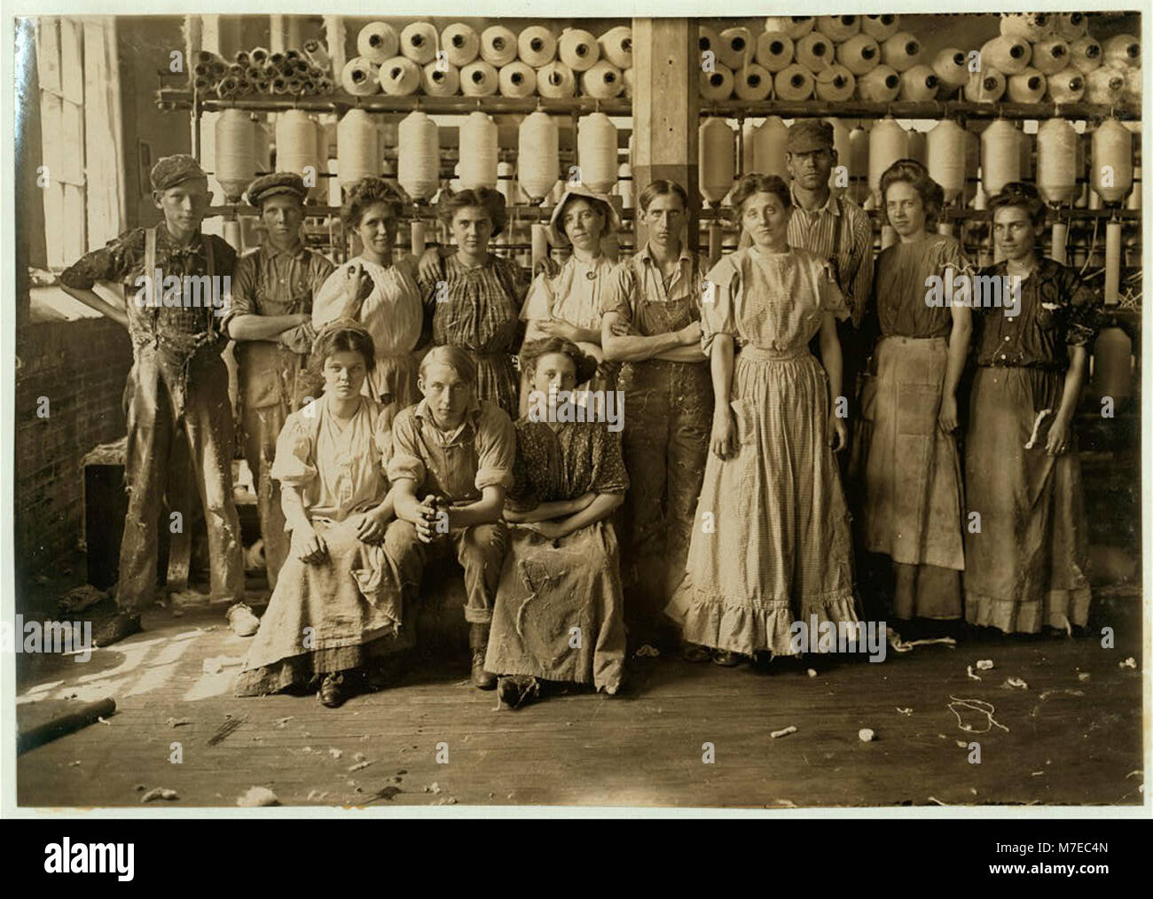 This photograph shows cotton mill workers during the noon hour in ...
