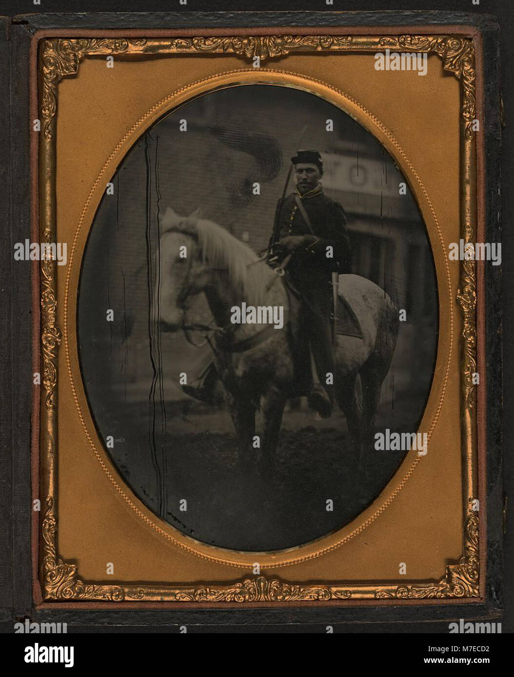 An outdoor scene depicting a mounted cavalry soldier seated on ...