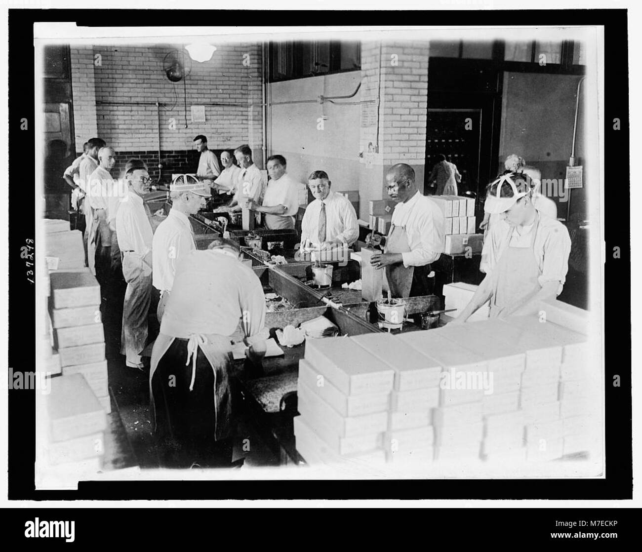 A photograph depicting the process of packing small-sized currency at ...